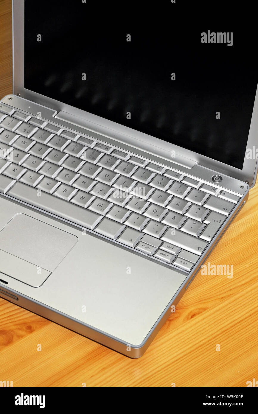 Open silver metal notebook at wooden desk Stock Photo - Alamy