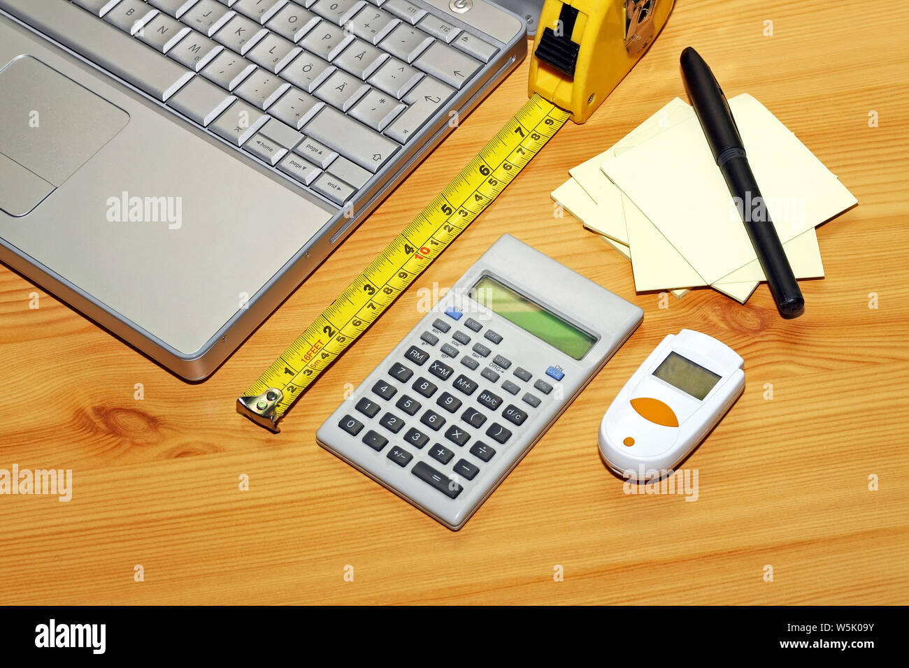 Measuring Tape and Calculator at Wooden Desk Stock Photo - Alamy