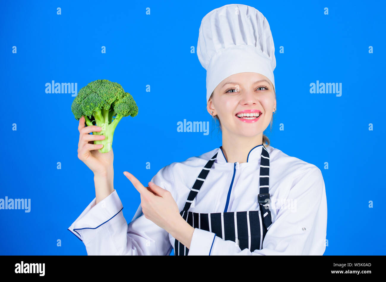 Broccoli has impressive nutritional profile. Woman chef hold broccoli ...