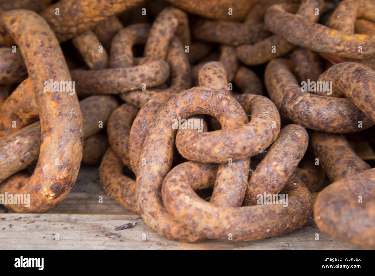 Rusty iron chains on a blue wooden pallet Stock Photo - Alamy