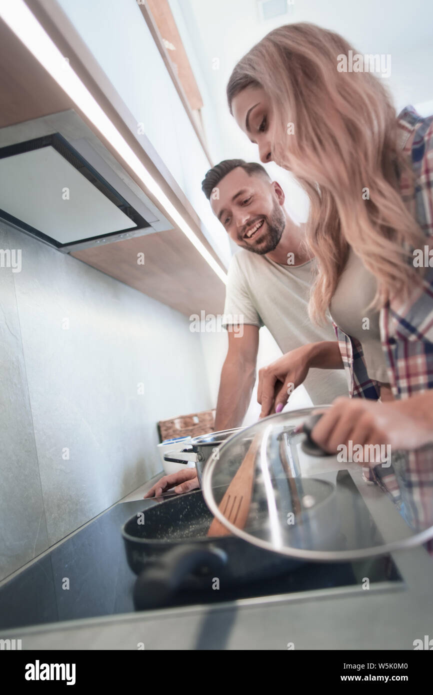 young husband and wife cook dinner together Stock Photo - Alamy