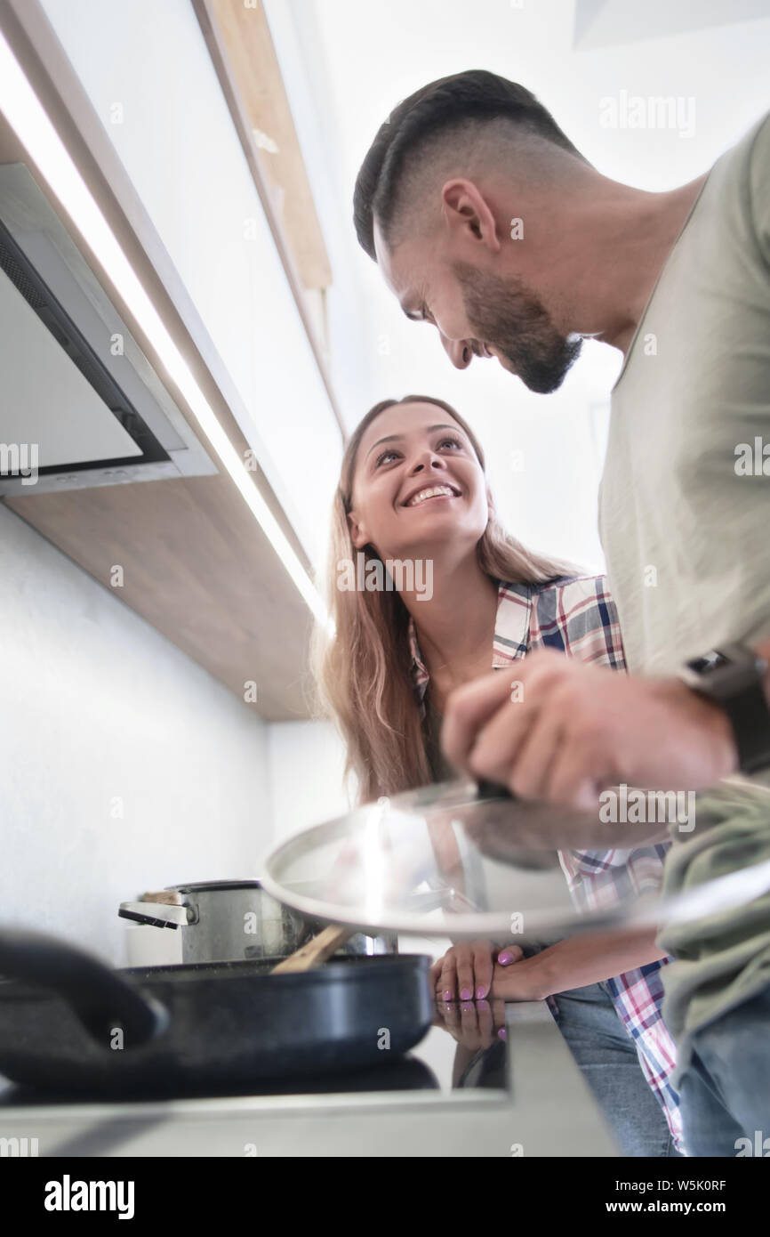 young husband and wife cook dinner together Stock Photo - Alamy