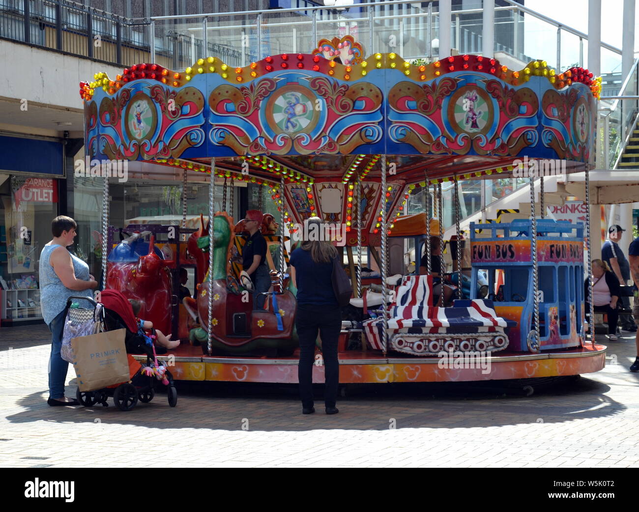 Children on a roundabout at a fun fair hi-res stock photography and ...