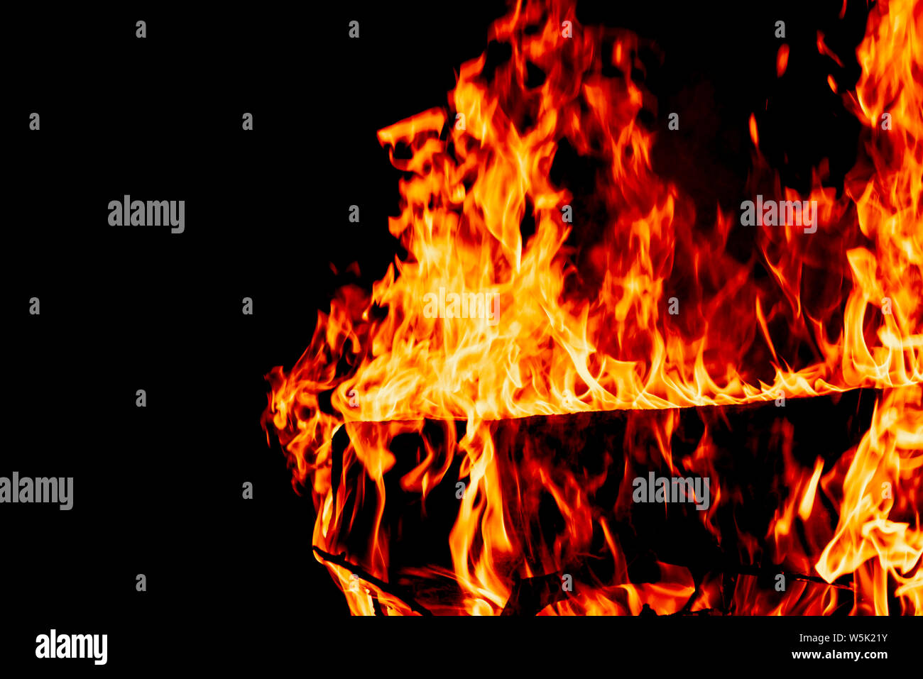 Wood fire on black background.Fire on a dark background. Background ...