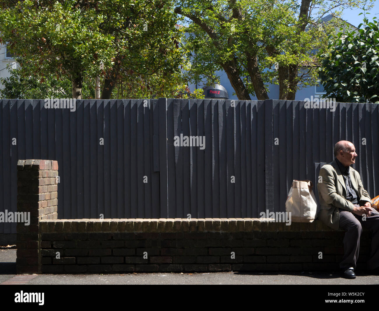 Elderly man sitting outside shop hi-res stock photography and images ...