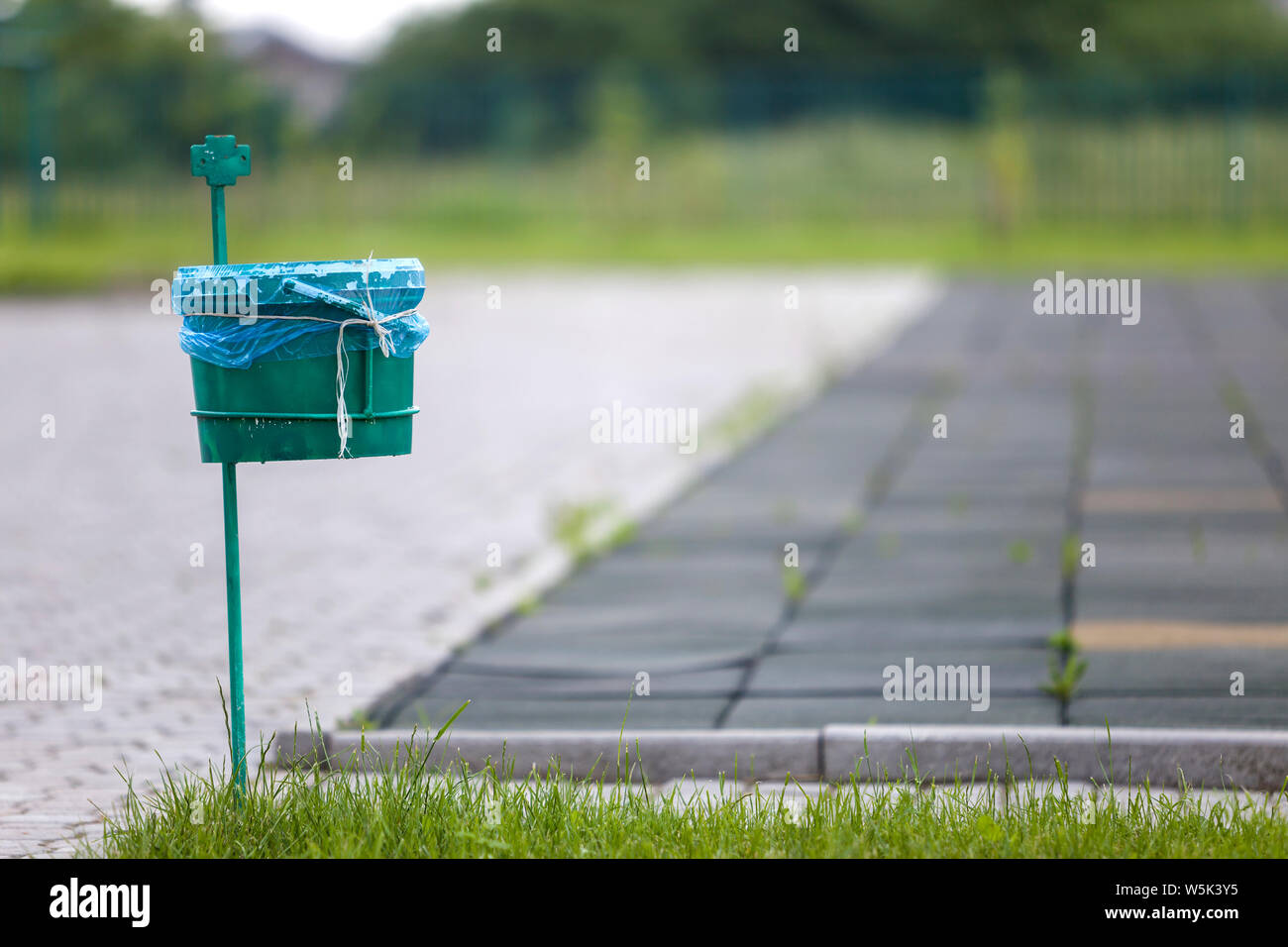 Garbage bin outdoor on blurred sunny background Stock Photo - Alamy