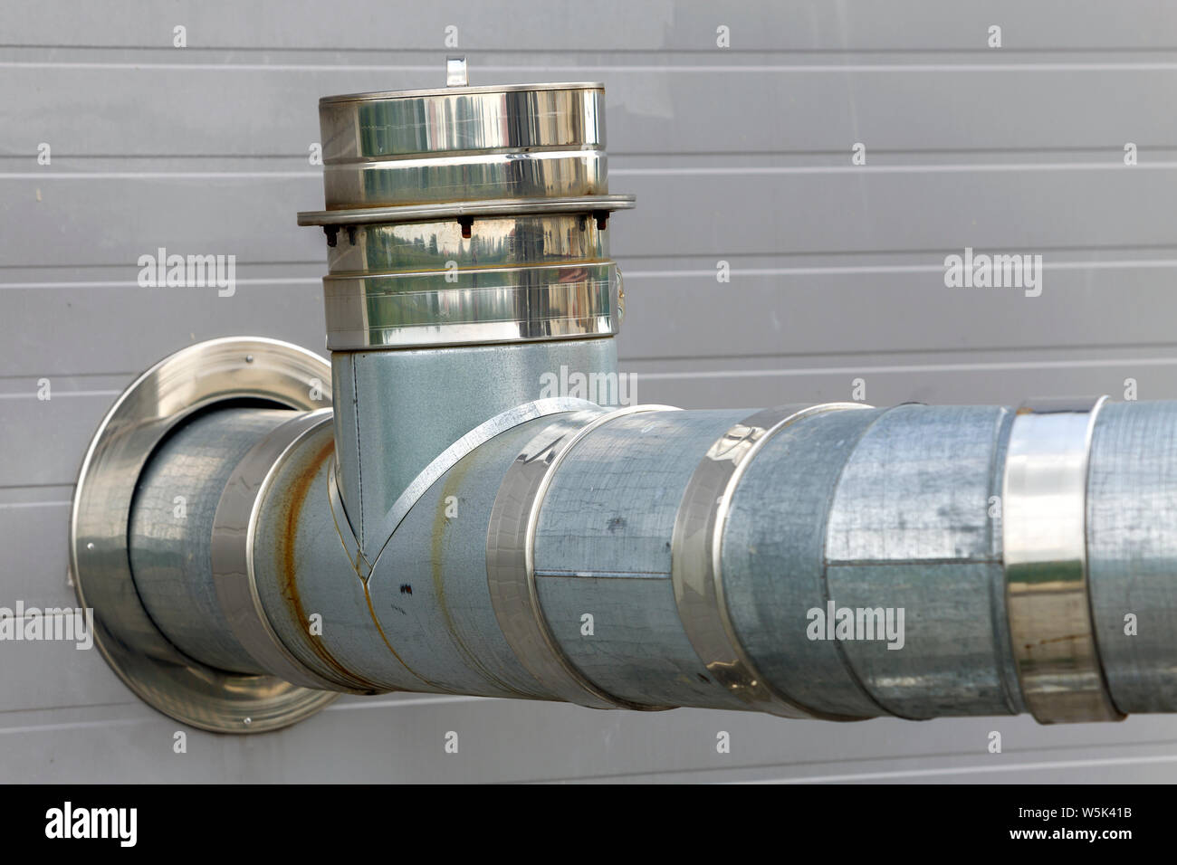 Metallic exhaust smoke pipes installed on house exterior wall Stock ...