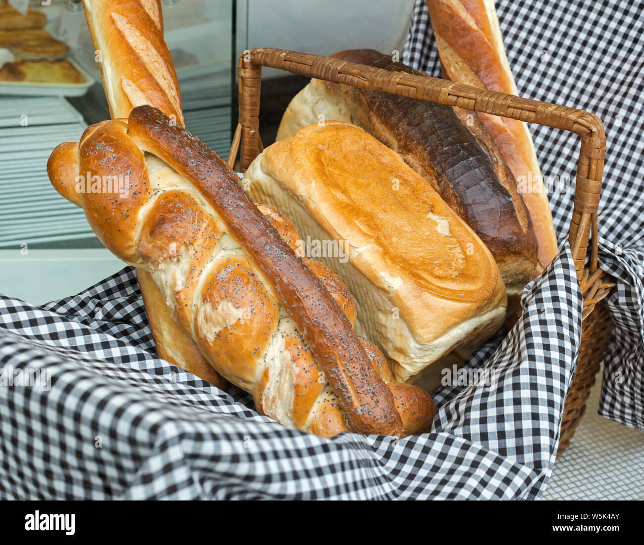 Bread basket with artisan made breads and a blue gingham cloth Stock ...