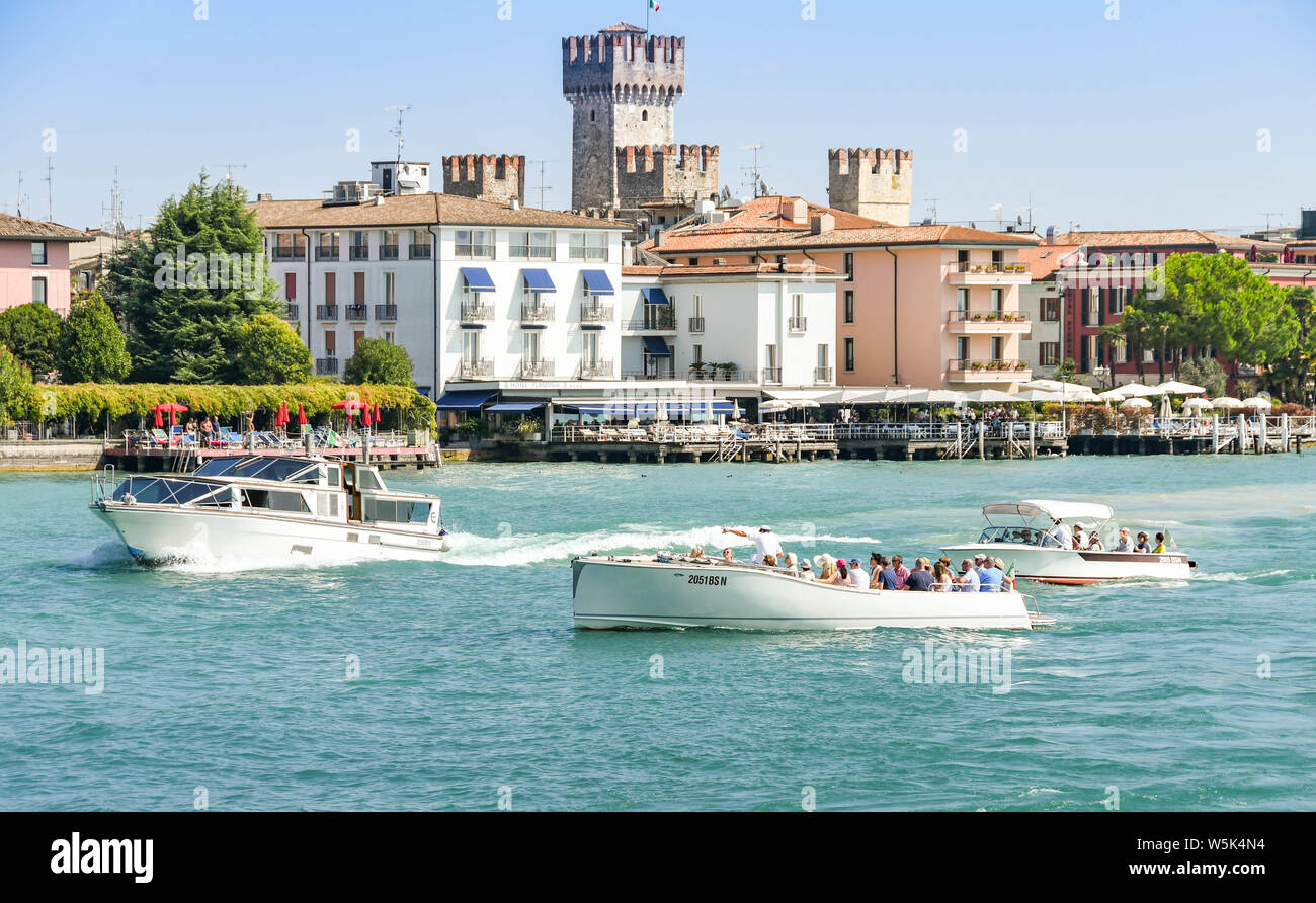LAKE GARDA, ITALY - SEPTEMBER 2018: Motor cruiser and boats on calm ...
