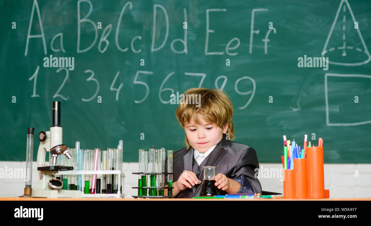 Happy childhood. Child enjoy studying. Boy near microscope and test ...