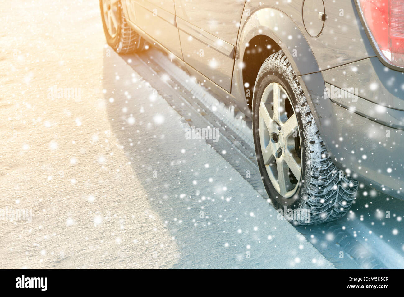 Close-up of car wheels rubber tires in deep winter snow. Transportation ...