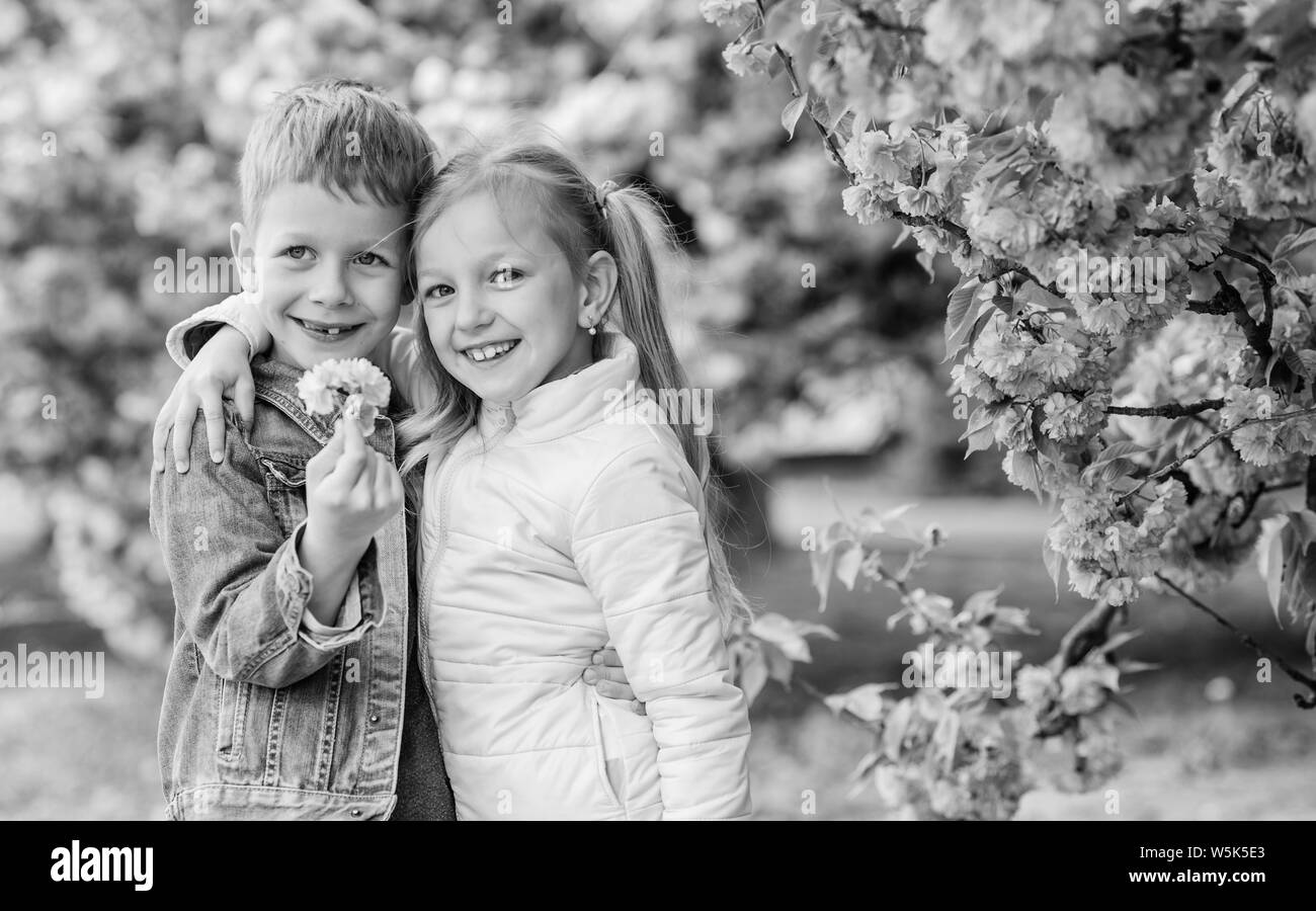 Romantic babies. Kids enjoying pink cherry blossom. Tender love ...