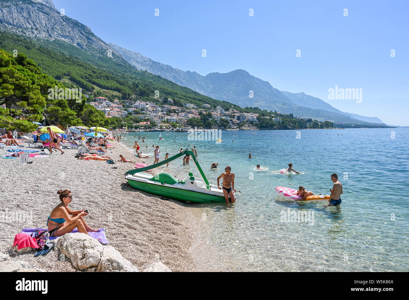 Tourists enjoy the beach at Brela. The Makarska riviera in Croatia is ...
