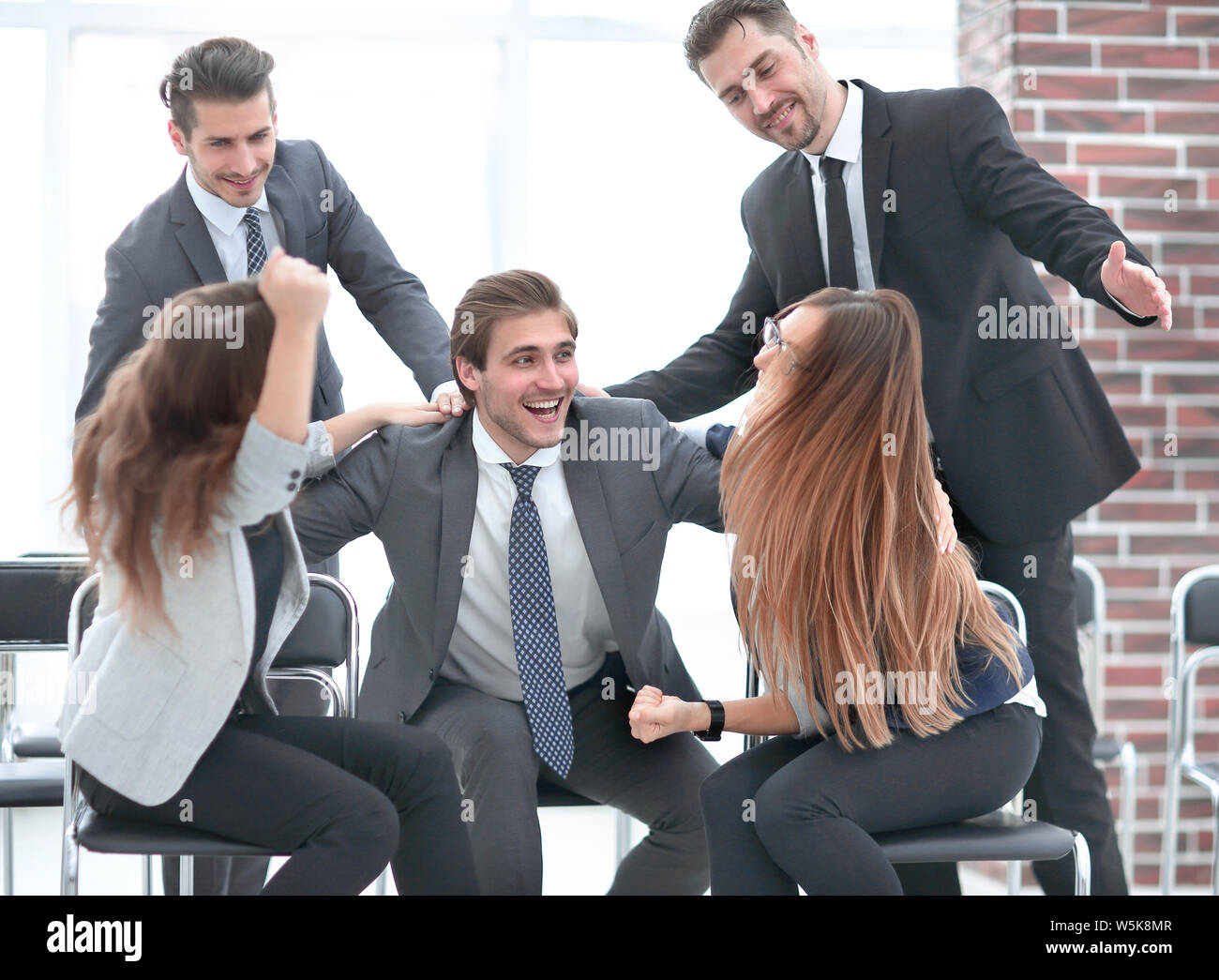 Hugging business people toasting to celebrate success Stock Photo - Alamy