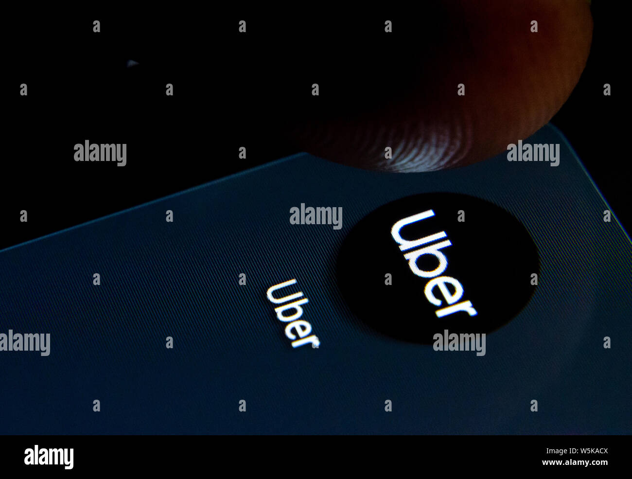Uber app icon on the smartphone screen with visible pixels and the ...