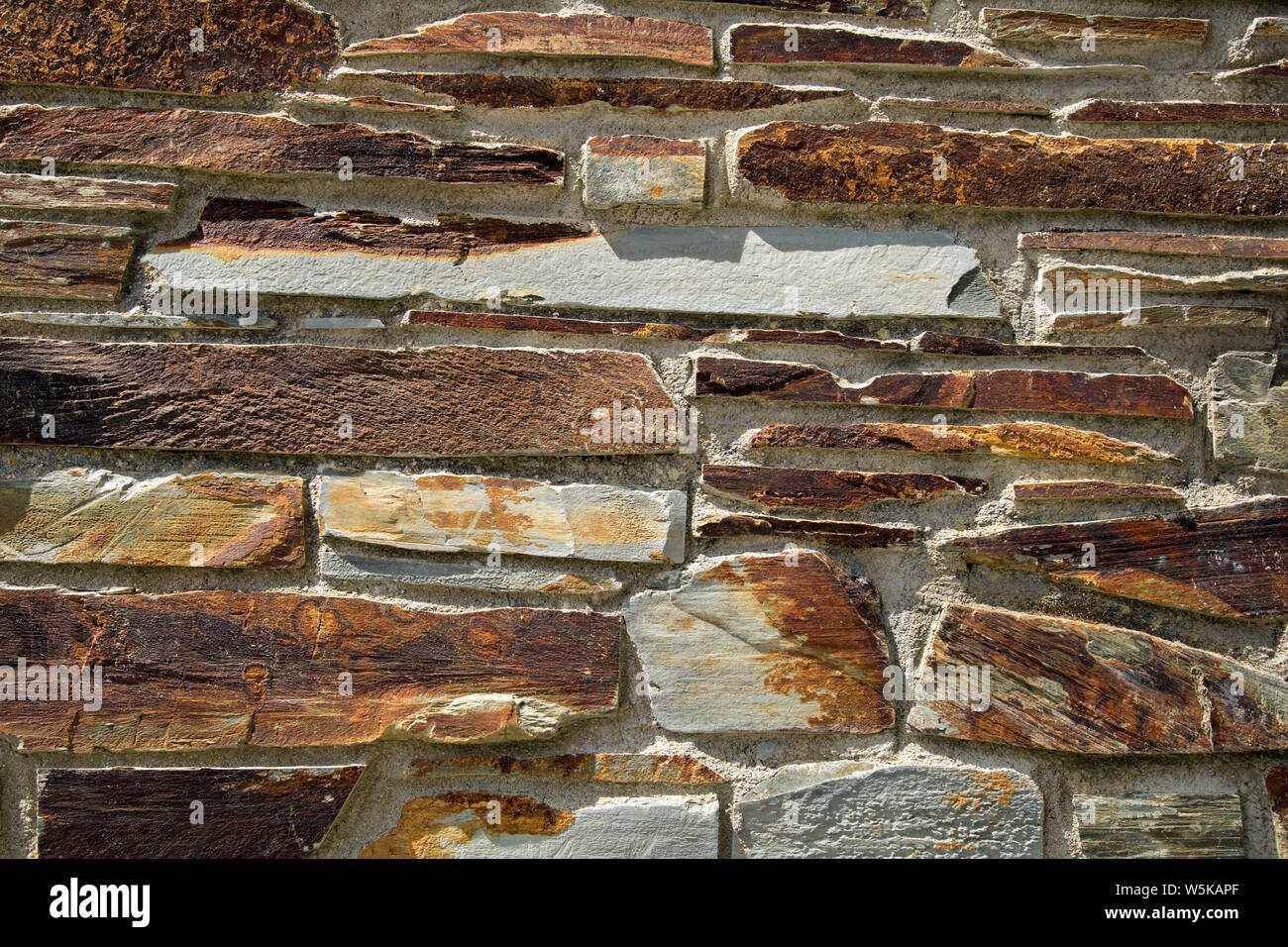Rust coloured stone brick wall shot close up for a background Stock ...