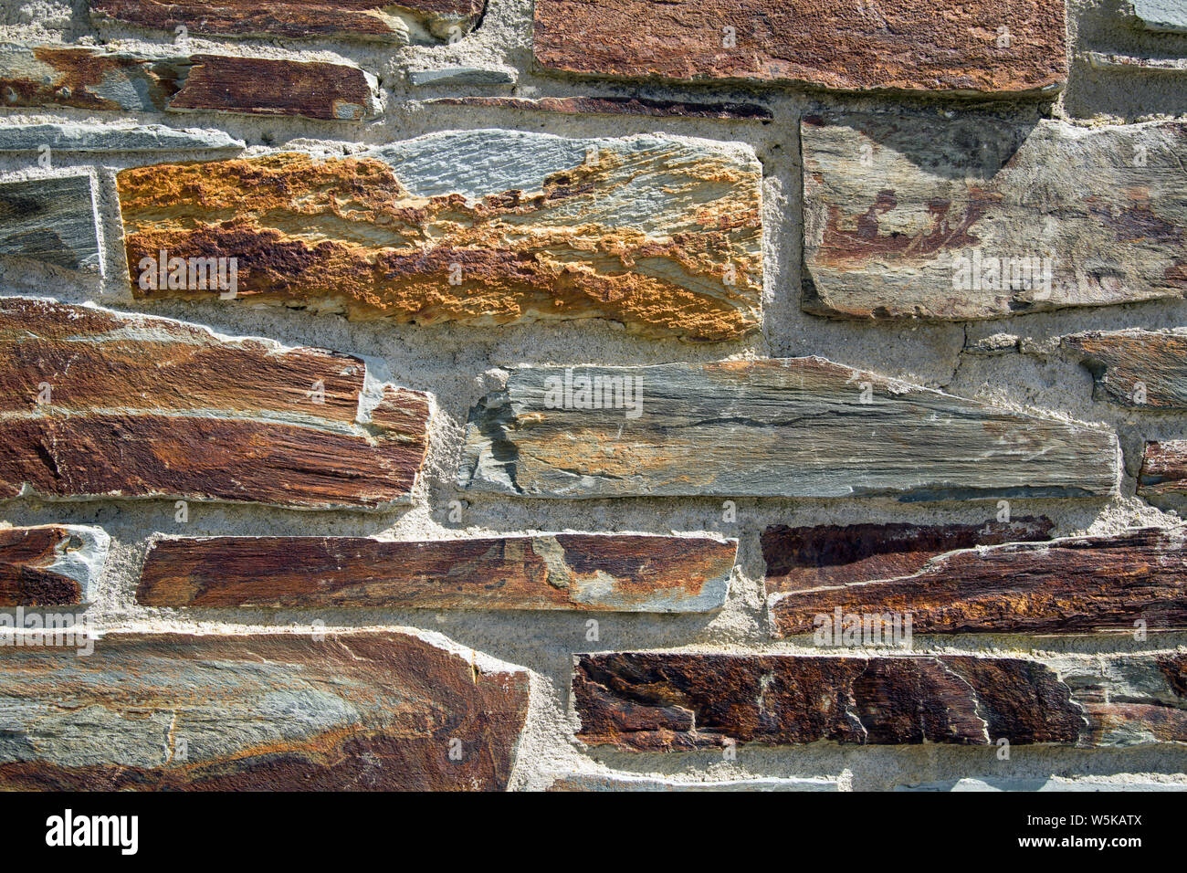 Rust coloured stone brick wall shot close up for a background Stock ...