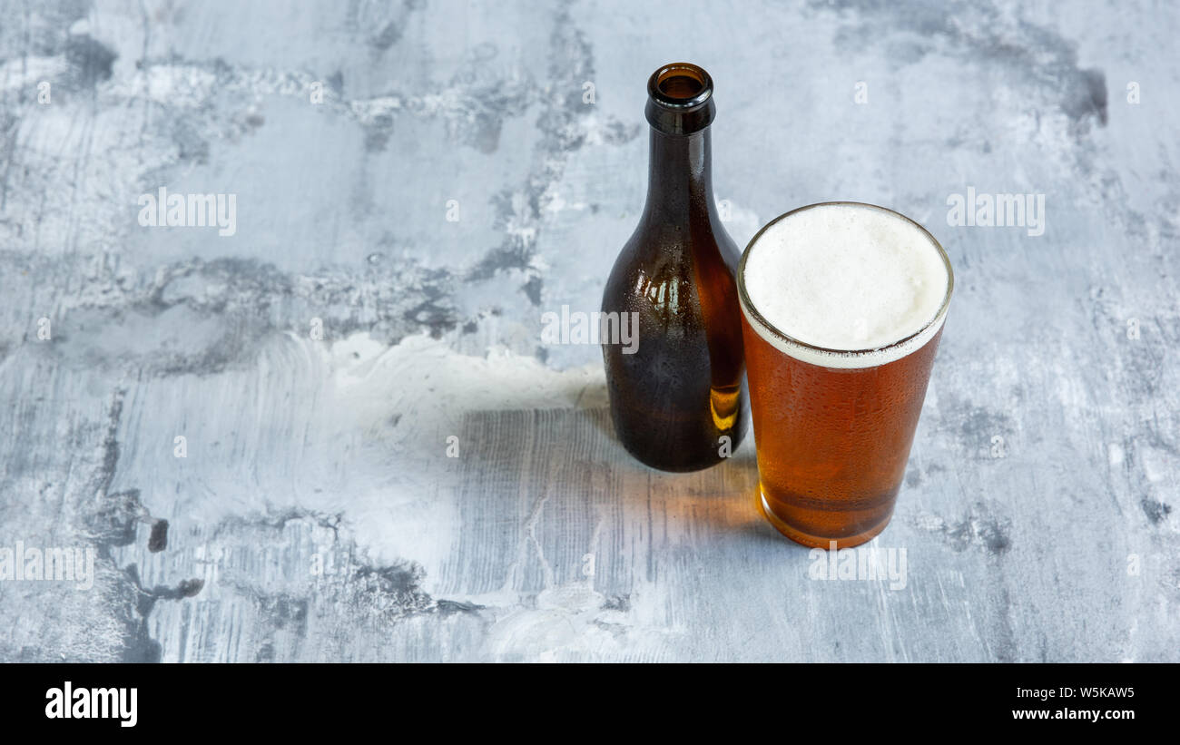 Glass of light beer on white stone background. Cold alcohol drink and ...