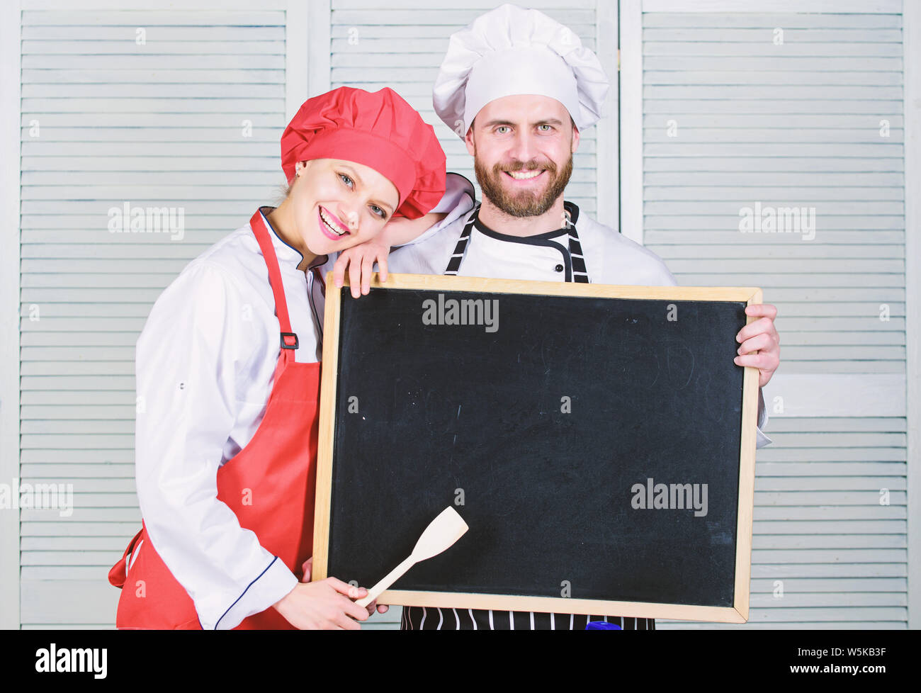 Mastering cooking skills. Couple of man and woman holding empty ...