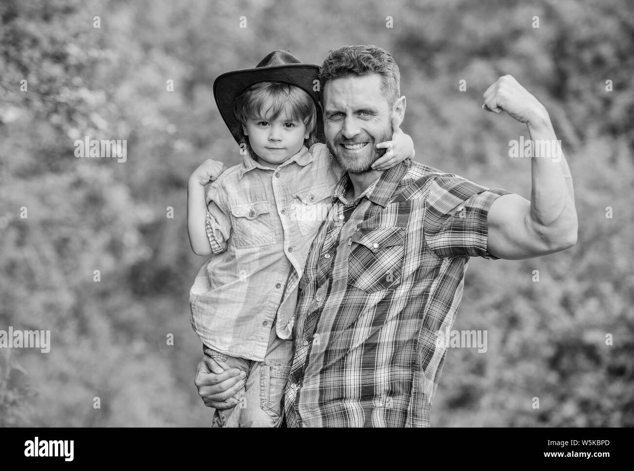 Rustic family. Growing cute cowboy. Small helper in garden. Little boy ...