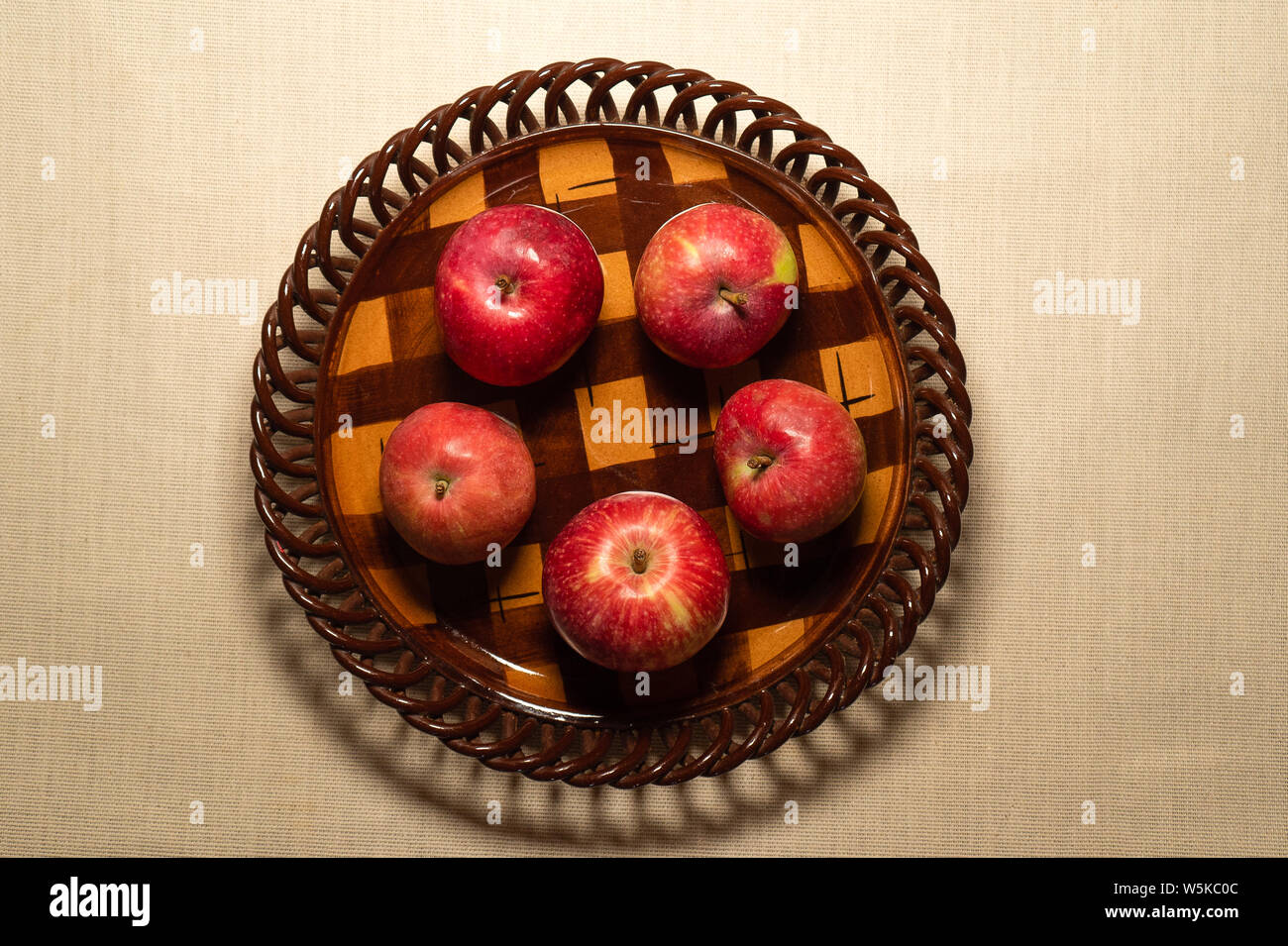 five red apples on the bowl are isolated on a white background, healthy ...