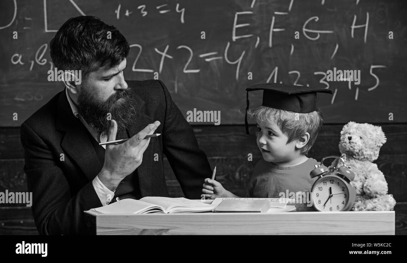 Happy family. Father and son doing homework together. Teacher in formal ...