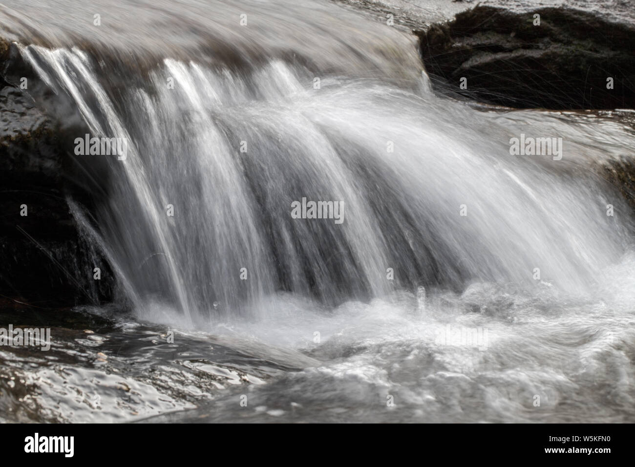 Water flowing over waterfall in mountain stream Australia Stock Photo ...