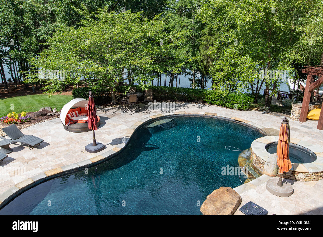 Luxurious outdoor pool with landscaping, in the backyard of a home ...