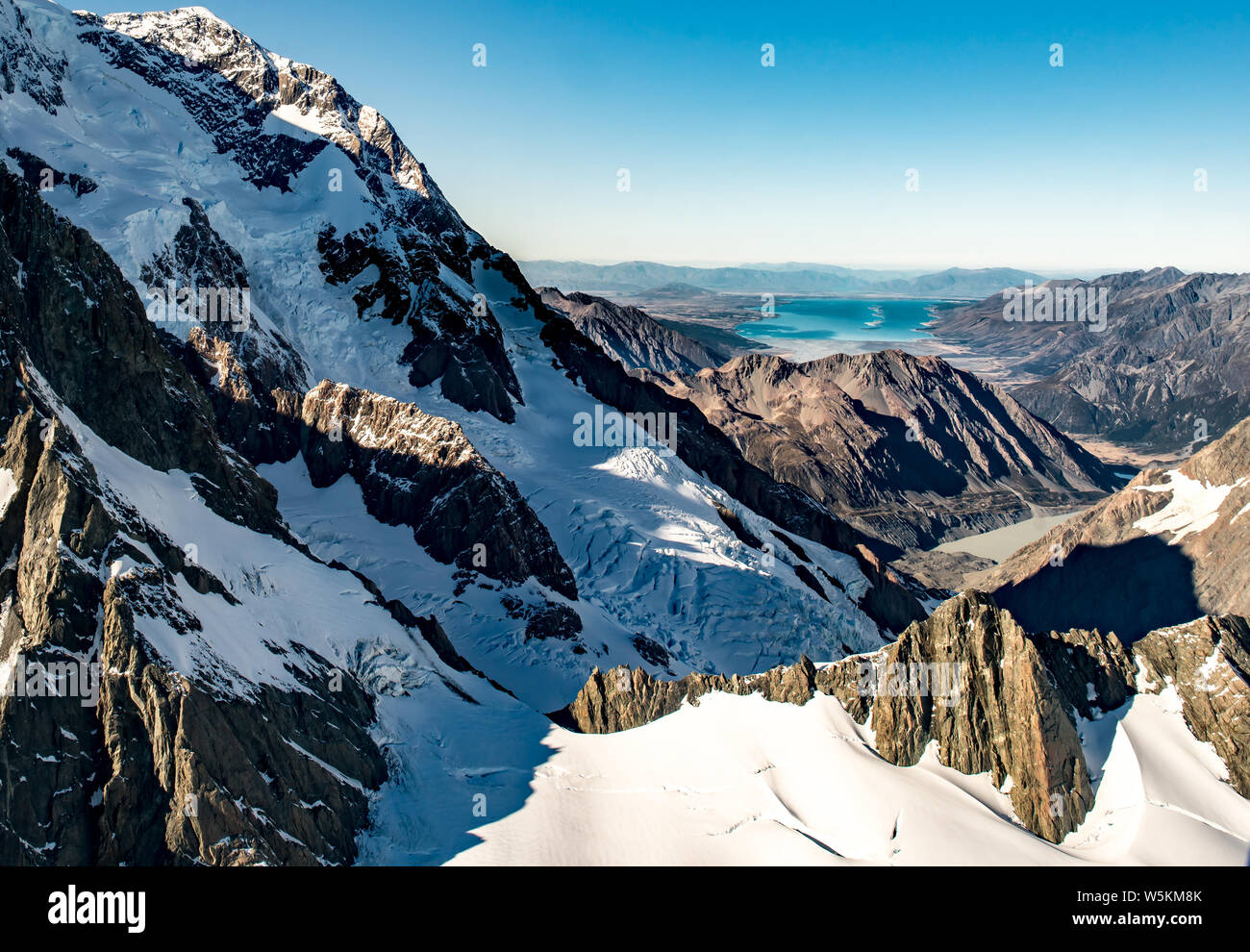 The tall peaks of the Southern Alps with Lake Pukaki in the distance ...