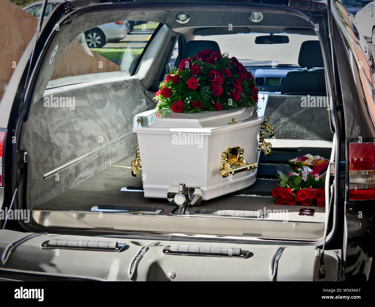 closeup shot of a funeral casket in a hearse or chapel or burial at ...