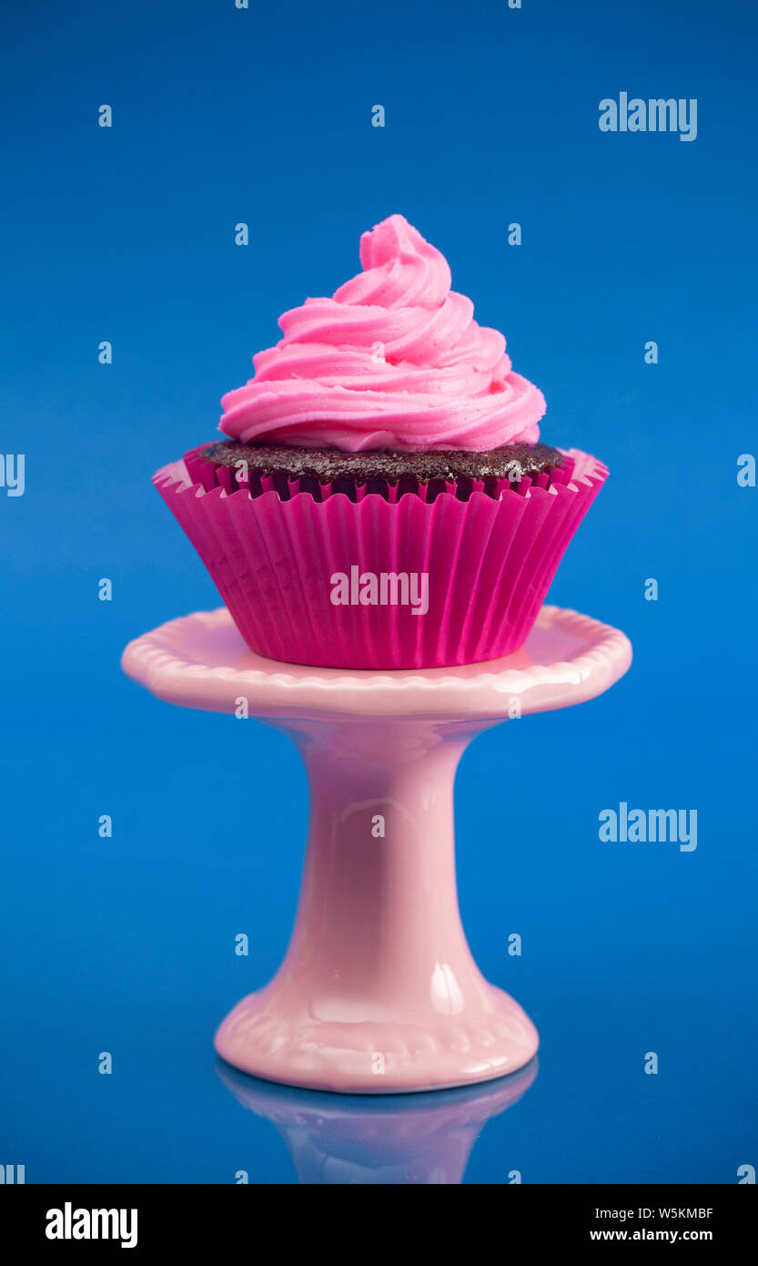 A Single Pink Cupcake on a Stand Stock Photo - Alamy