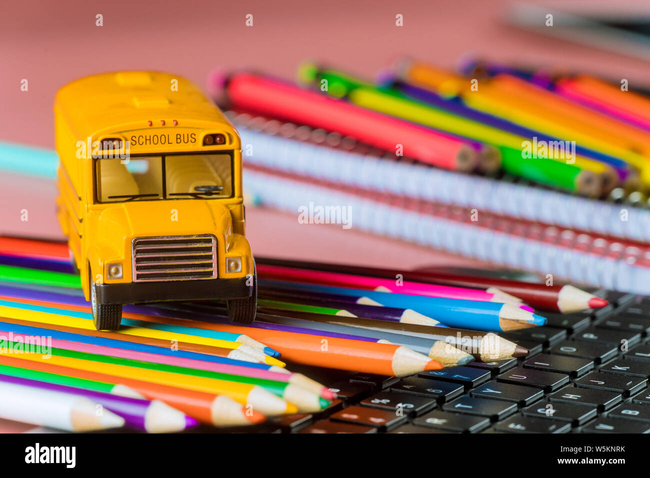 Yellow school bus on color pencils and keyboard, back to school Stock ...