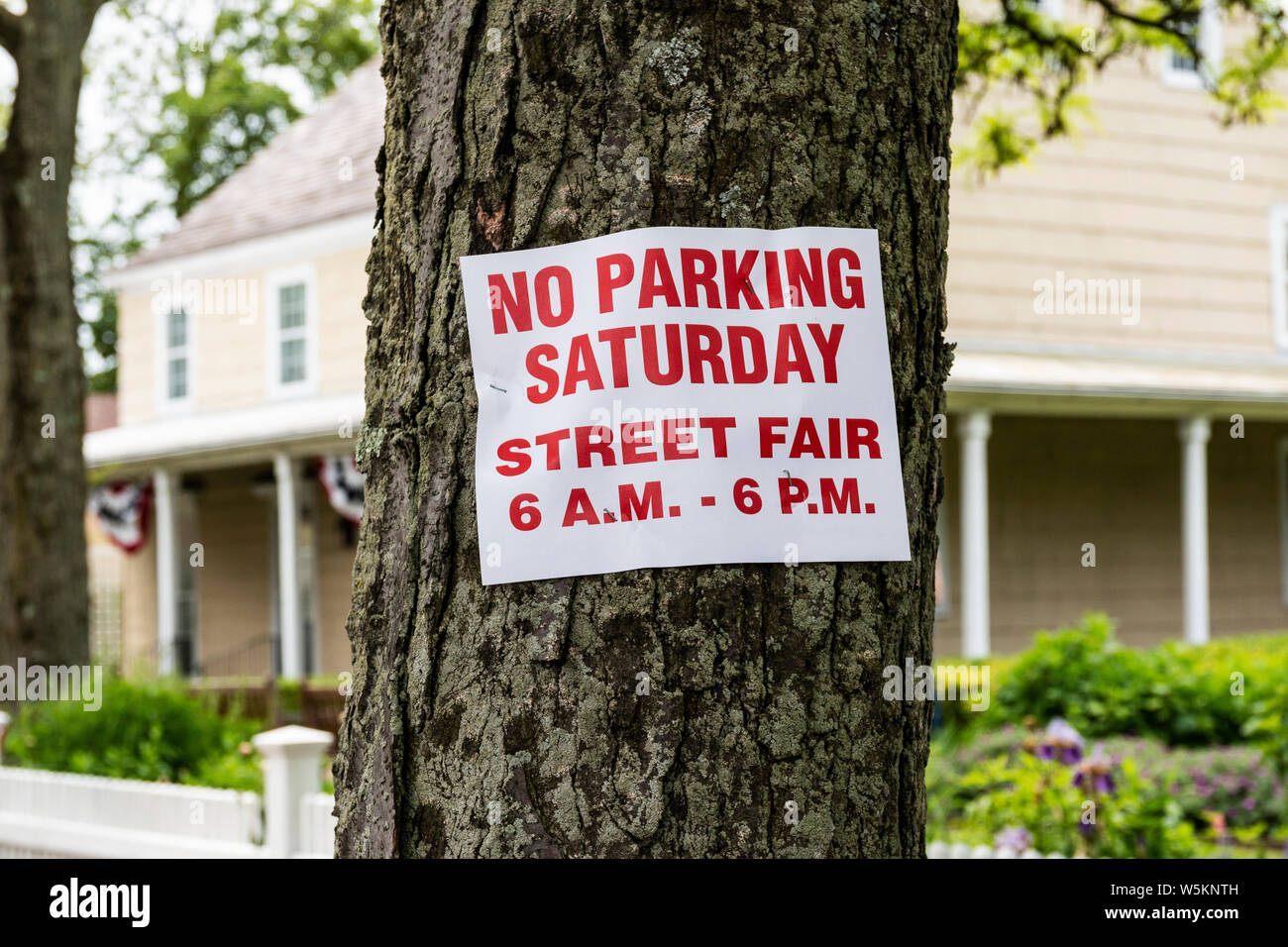 A no parking on Saturday sign is stapled to a tree because of a street ...
