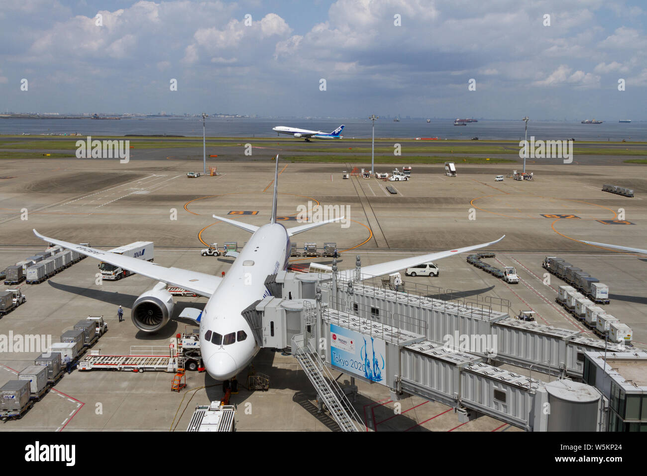 An All Nippon Airways (ANA) Boeing 777-281(ER) as another ANA passenger ...