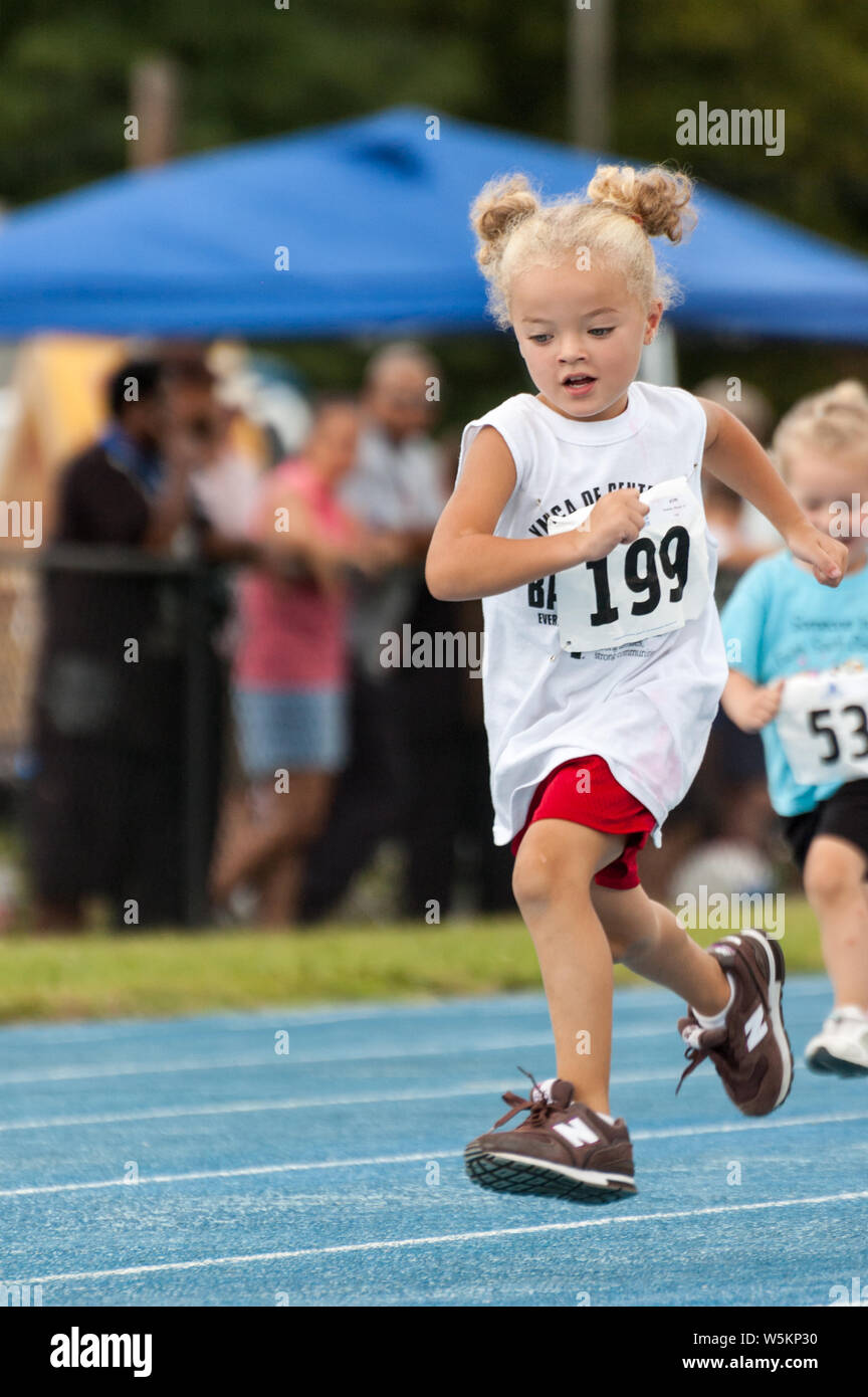 Young girl running in a competitive race in the Bluegrass State Games ...