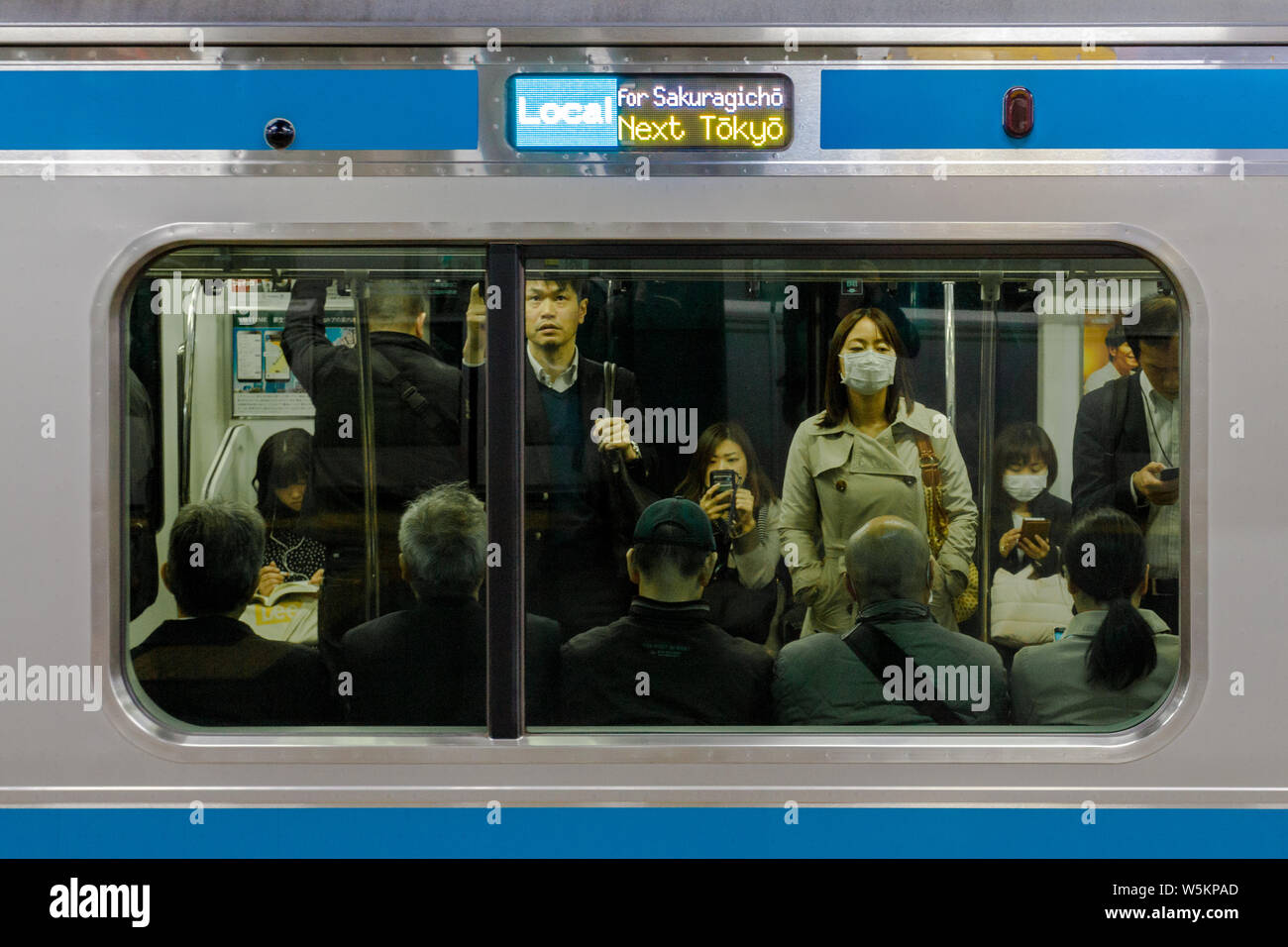 Commuters seen through the window of a commuter train in Kanda, Tokyo, Japan Stock Photo - Alamy