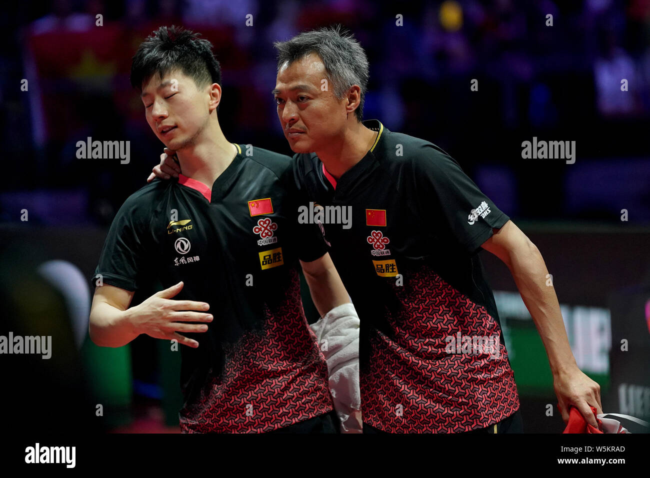 Ma Long of China celebrates with his coach Qin Zhijian after defeating ...