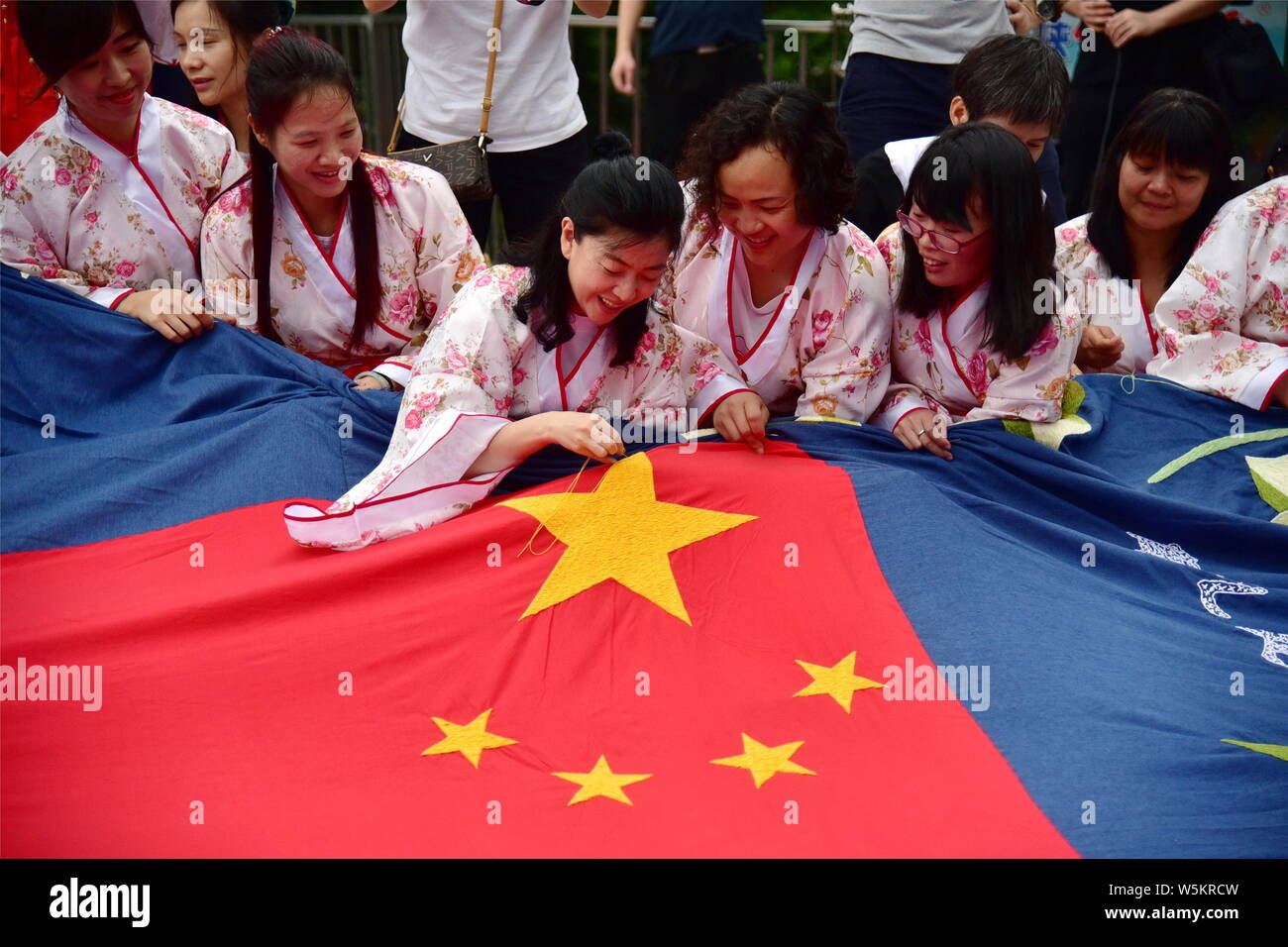 Craftswomen make a huge national flag to mark the 70th anniversary of ...