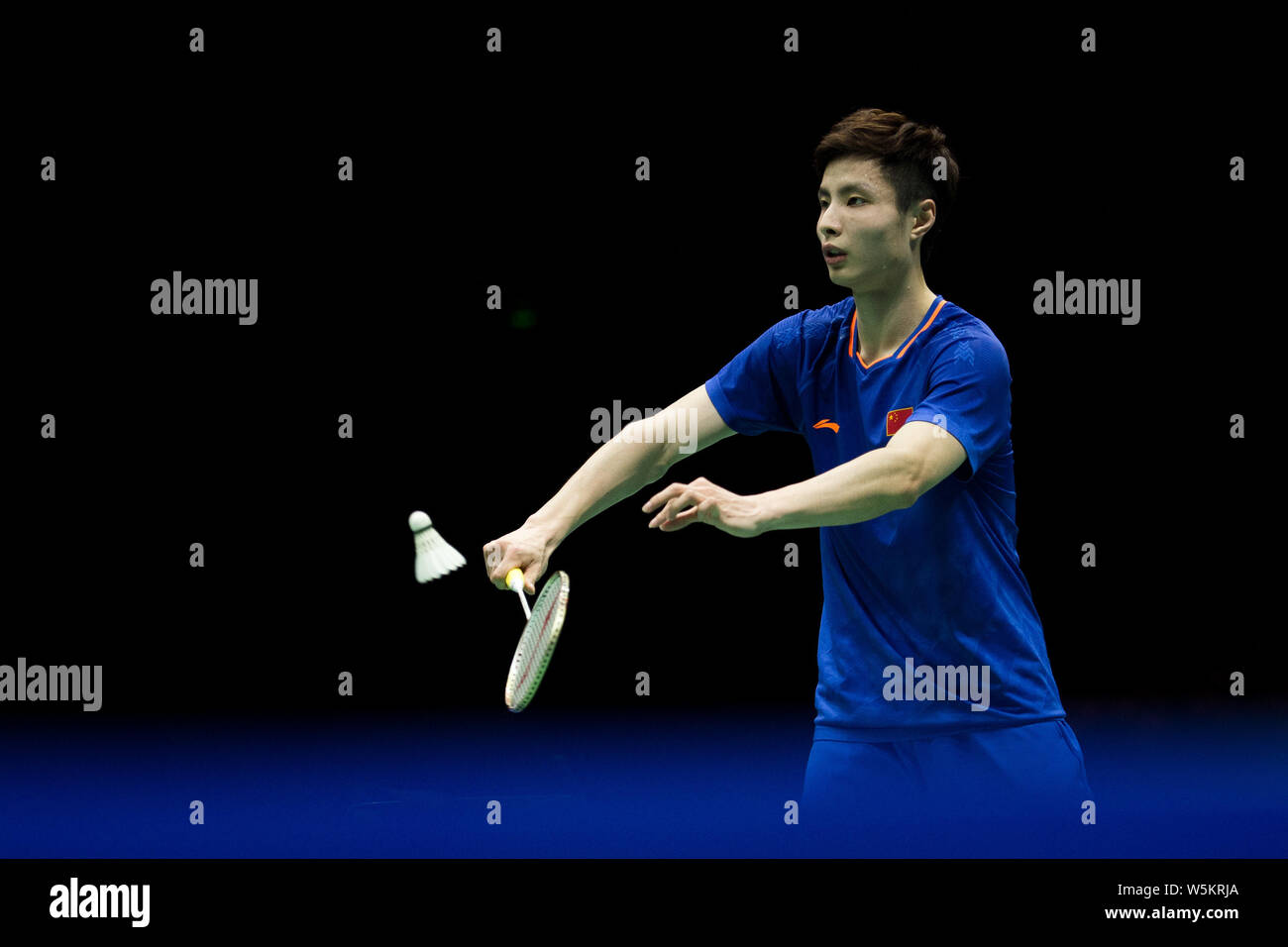 Shi Yuqi of China serves against Kento Momota of Japan in their final ...
