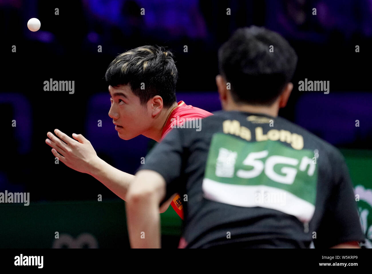 Liang Jingkun of China serves against Ma Long of China in their ...