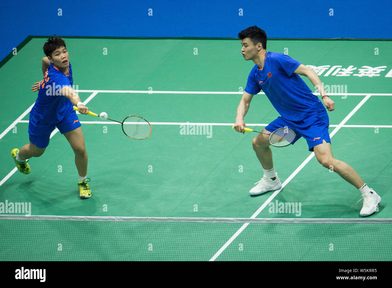 Wang Yilyu and Huang Dongping of China return a shot to He Jiting and ...