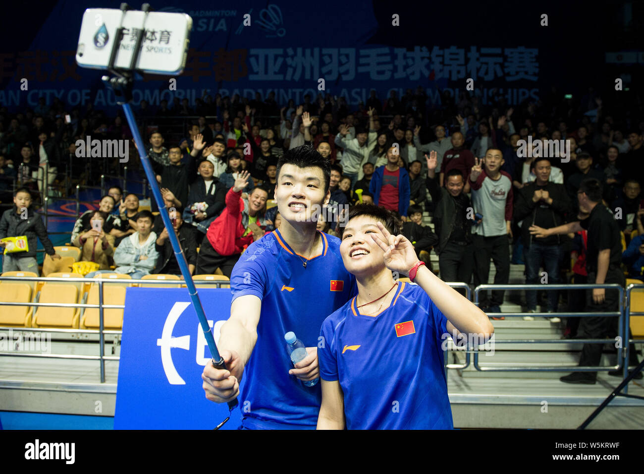 Wang Yilyu and Huang Dongping of China pose with their trophies after defeating He Jiting and Du ...