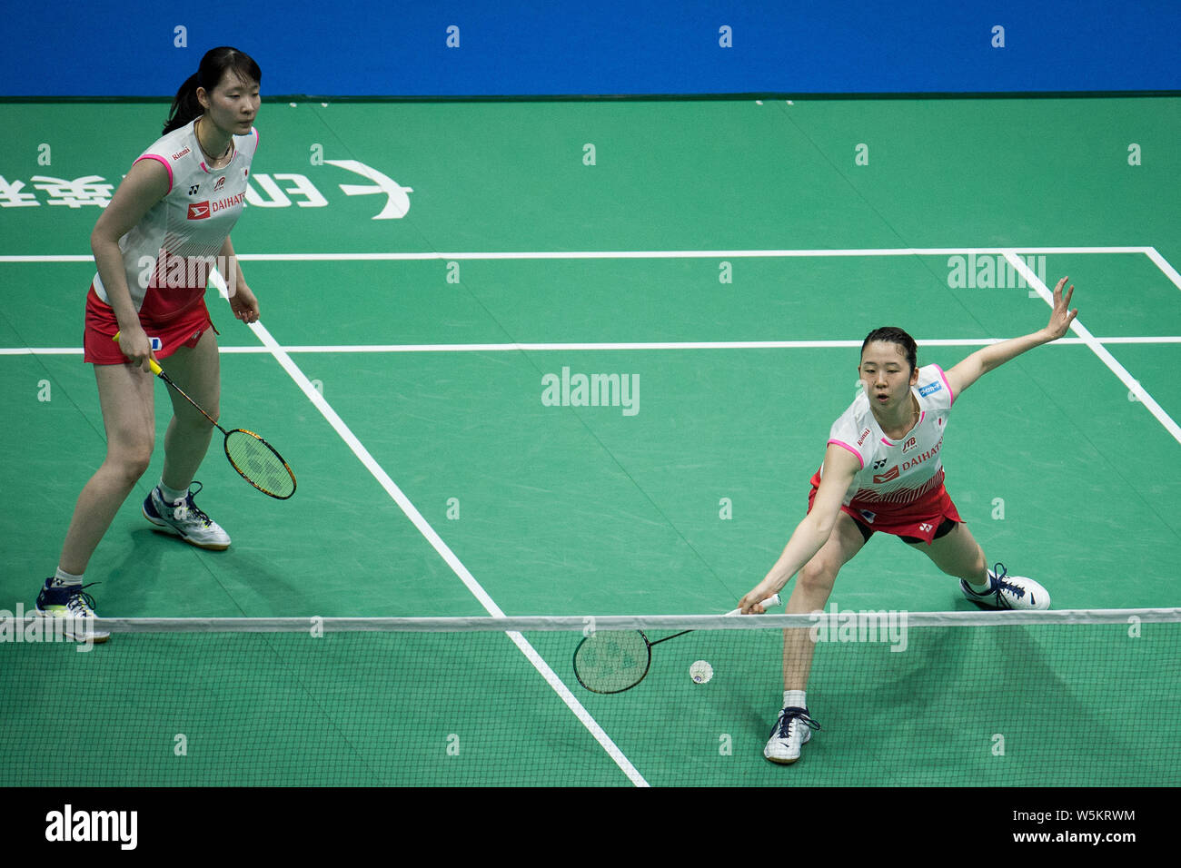 Mayu Matsumoto and Wakana Nagahara of Japan return a shot to Chen Qingchen and Jia Yifan of ...