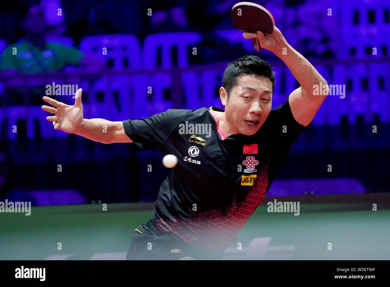 Xu Xin of China returns a shot to Simon Gauzy of France in their third ...