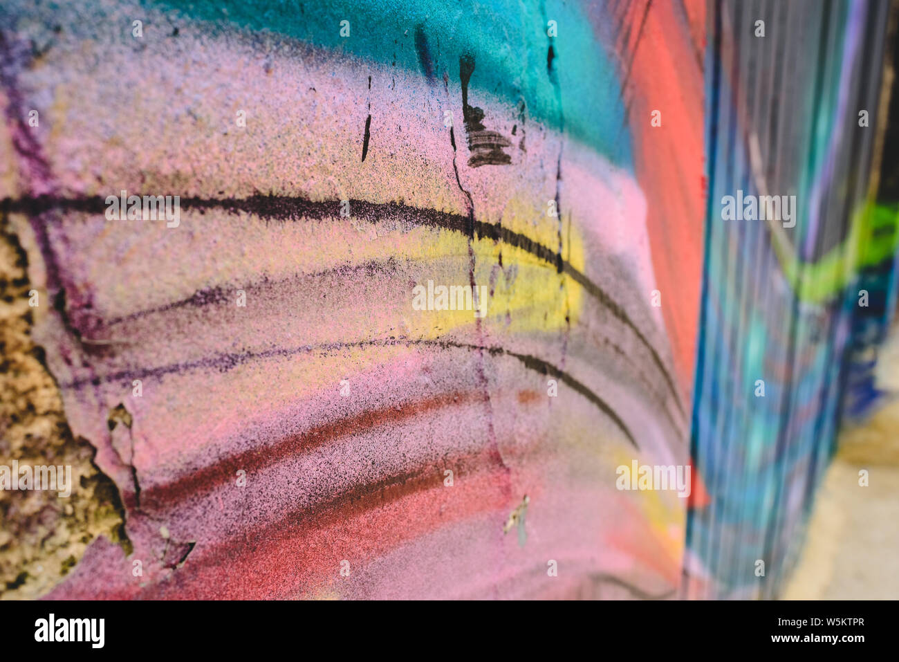 Detail of an anonymous street graffiti with many colors, cheerful urban ...