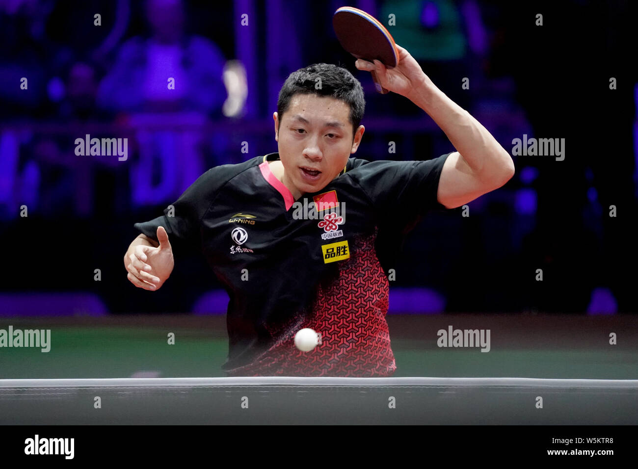 Xu Xin of China returns a shot to Simon Gauzy of France in their third ...