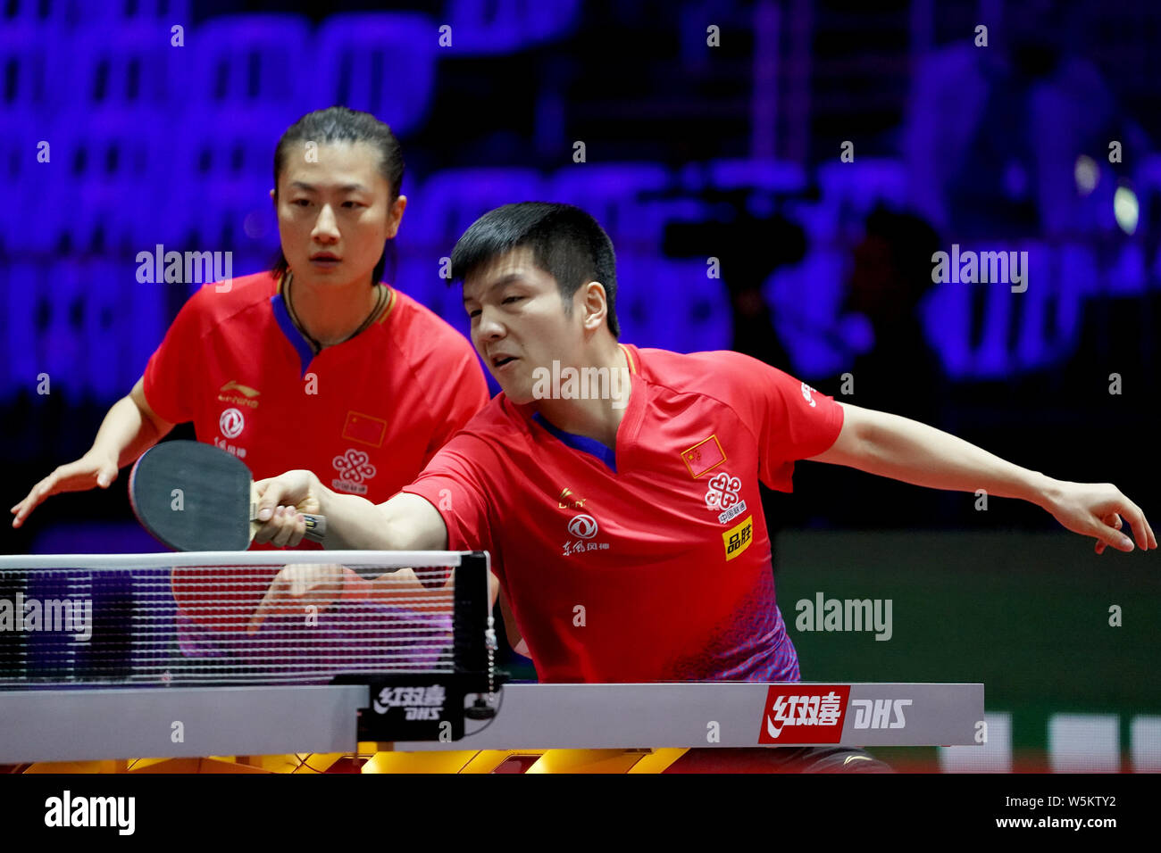 Fan Zhendong and Ding Ning of China return a shot to Tristan Flore and ...