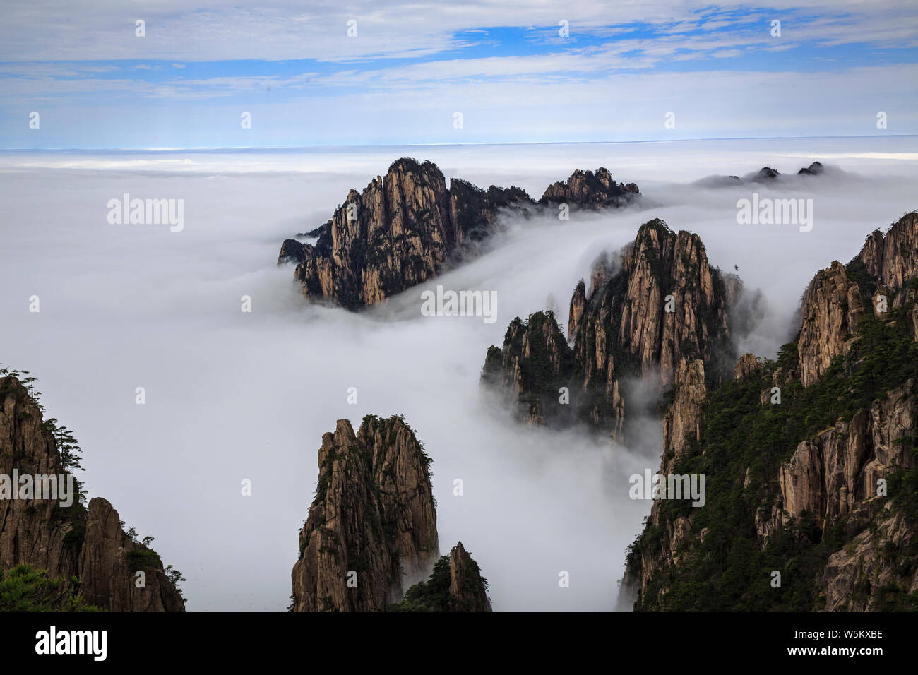 Landscape of the peaks and hills surrounded by clouds in the Huangshan Mountain scenic spot at ...