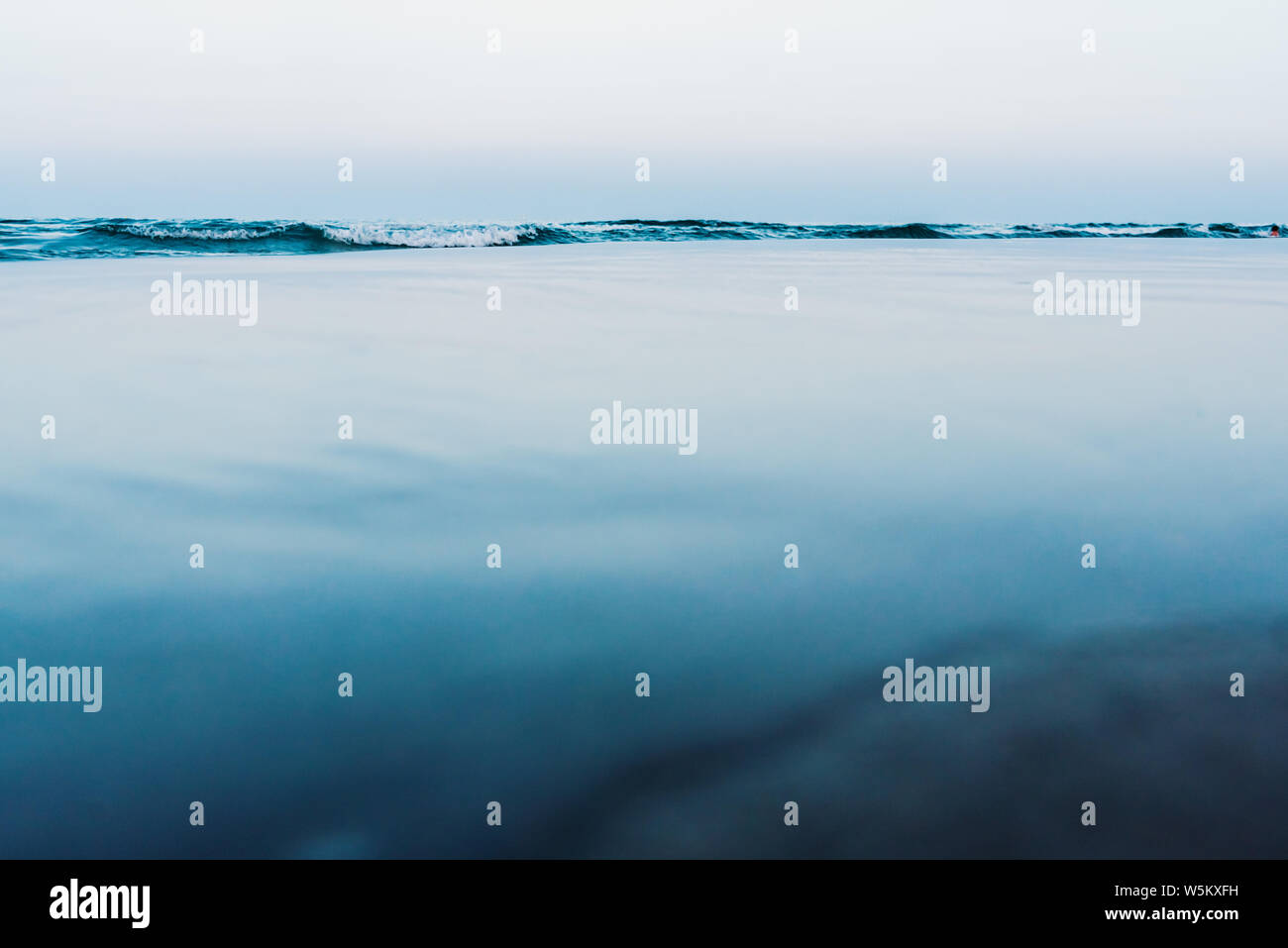 Silky calm water background with waves in the background and calm sea ...