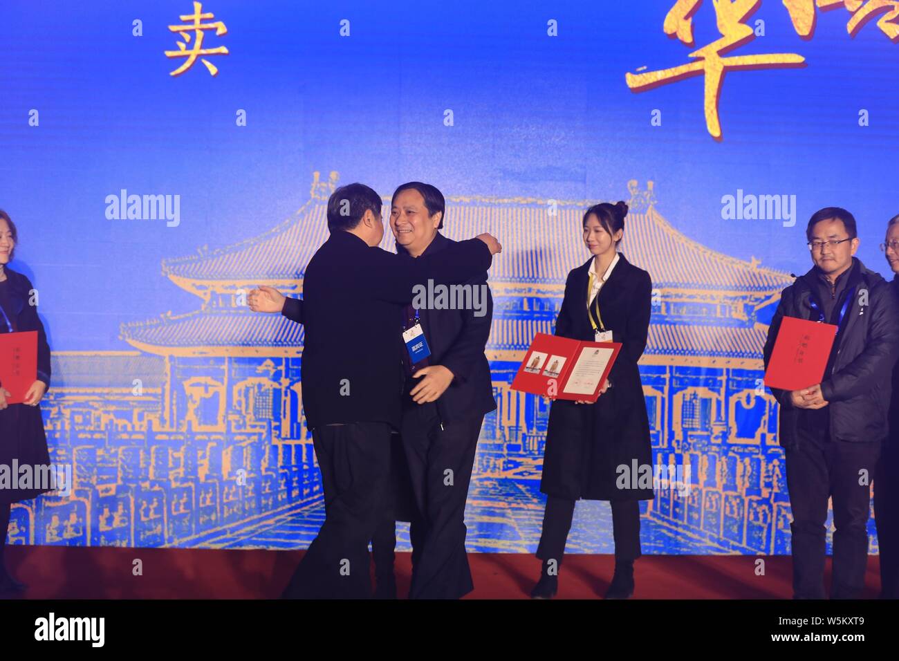 Shan Jixiang, left, the museum curator, issues the certificate for a ...